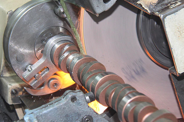 What does a car engine camshaft do?