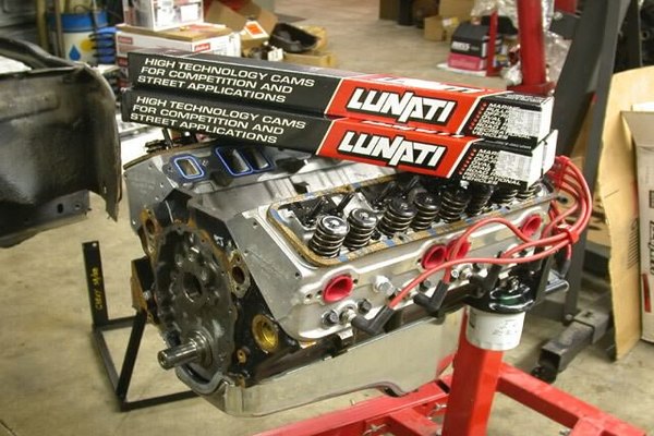 What does a car engine camshaft do?