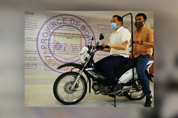 Is it safe to add a barrier on motorcycles for social distancing?